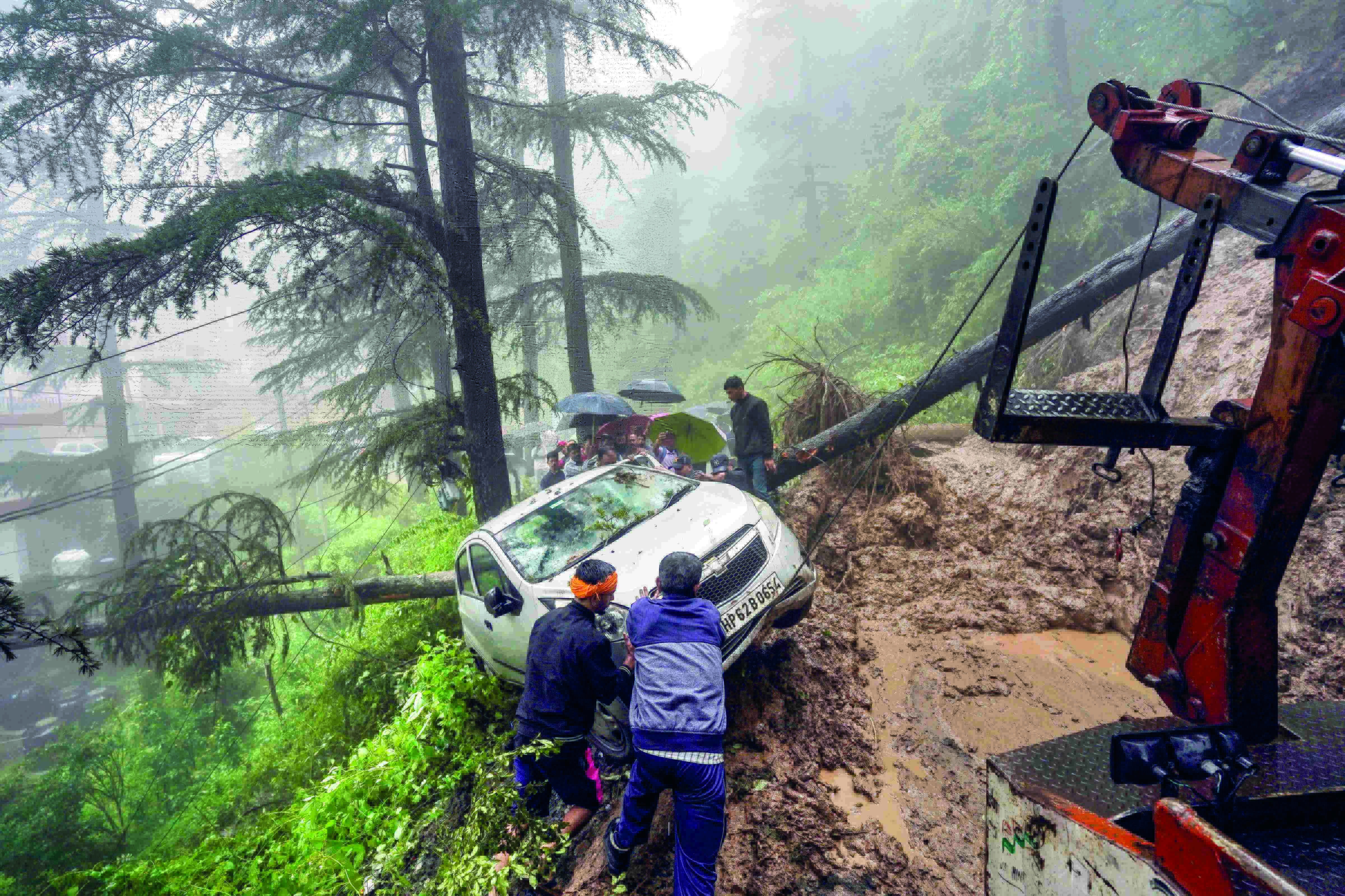 Heavy rains trigger landslides, block roads