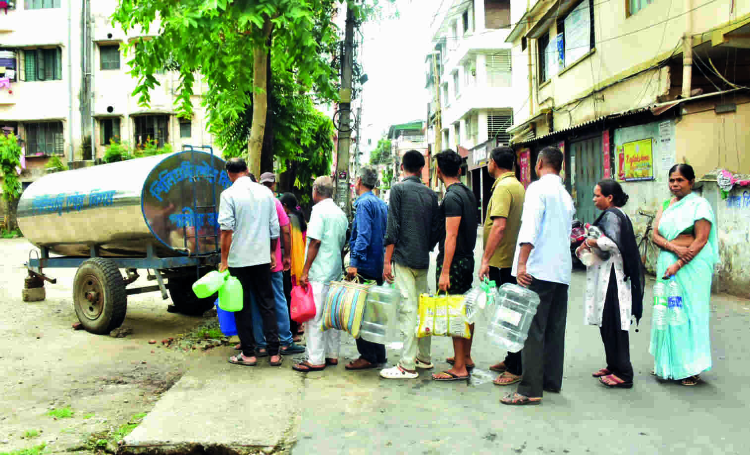 People stand in long queues in Siliguri for packaged water